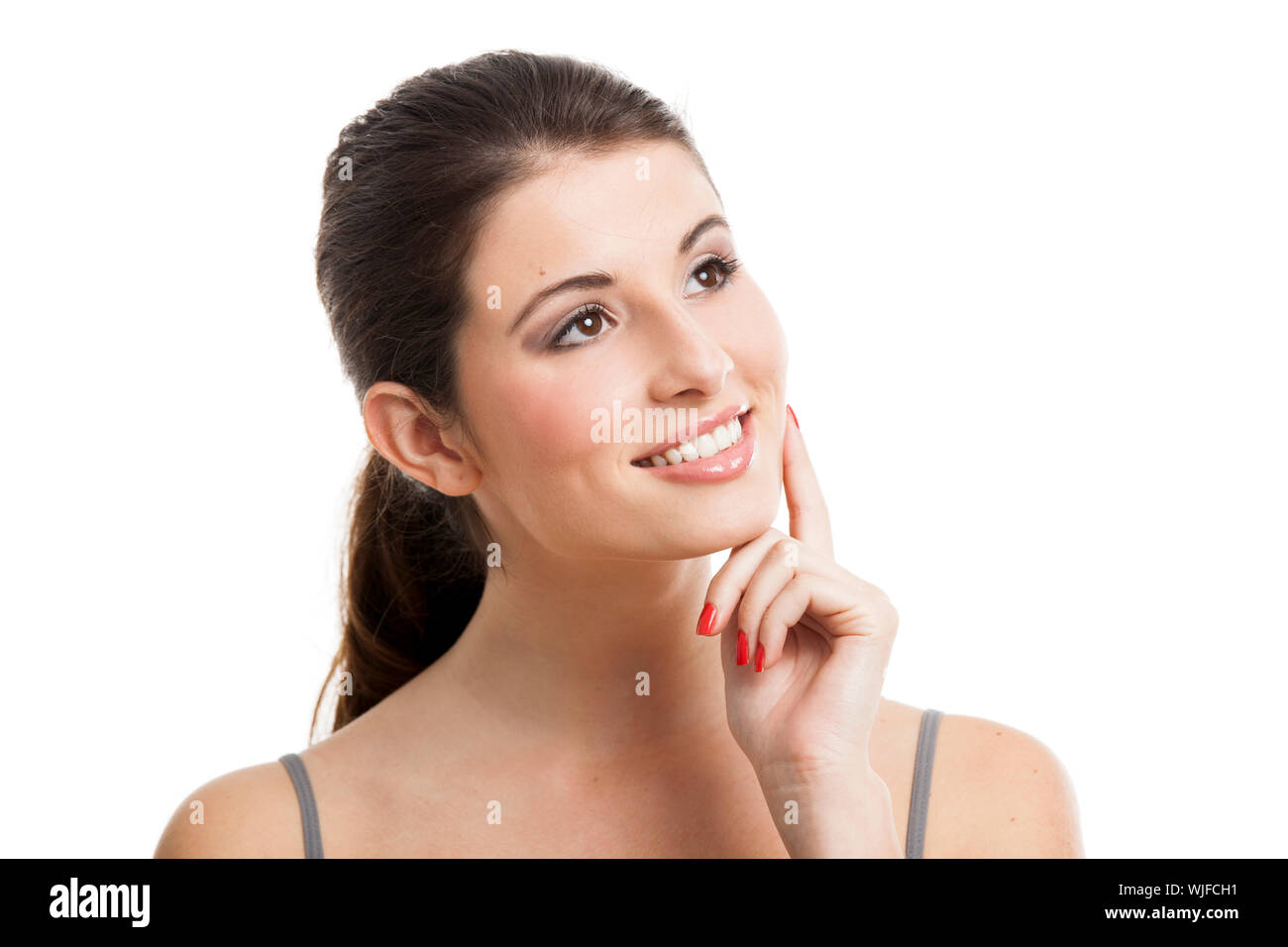 Studio portrait of a beautiful young woman with a thinking expression ...