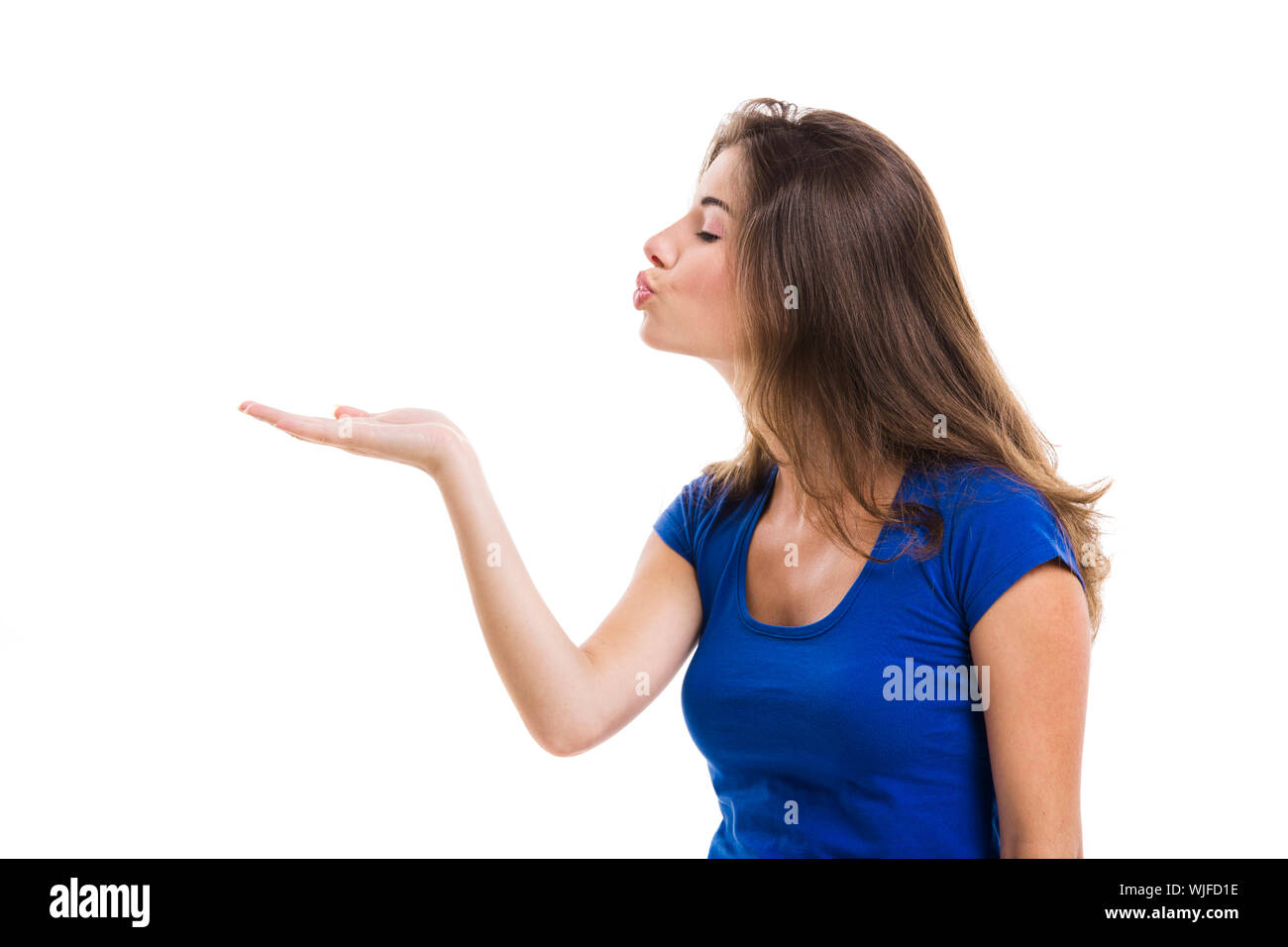 Beautiful young woman sending a kiss, isolated over a white background ...