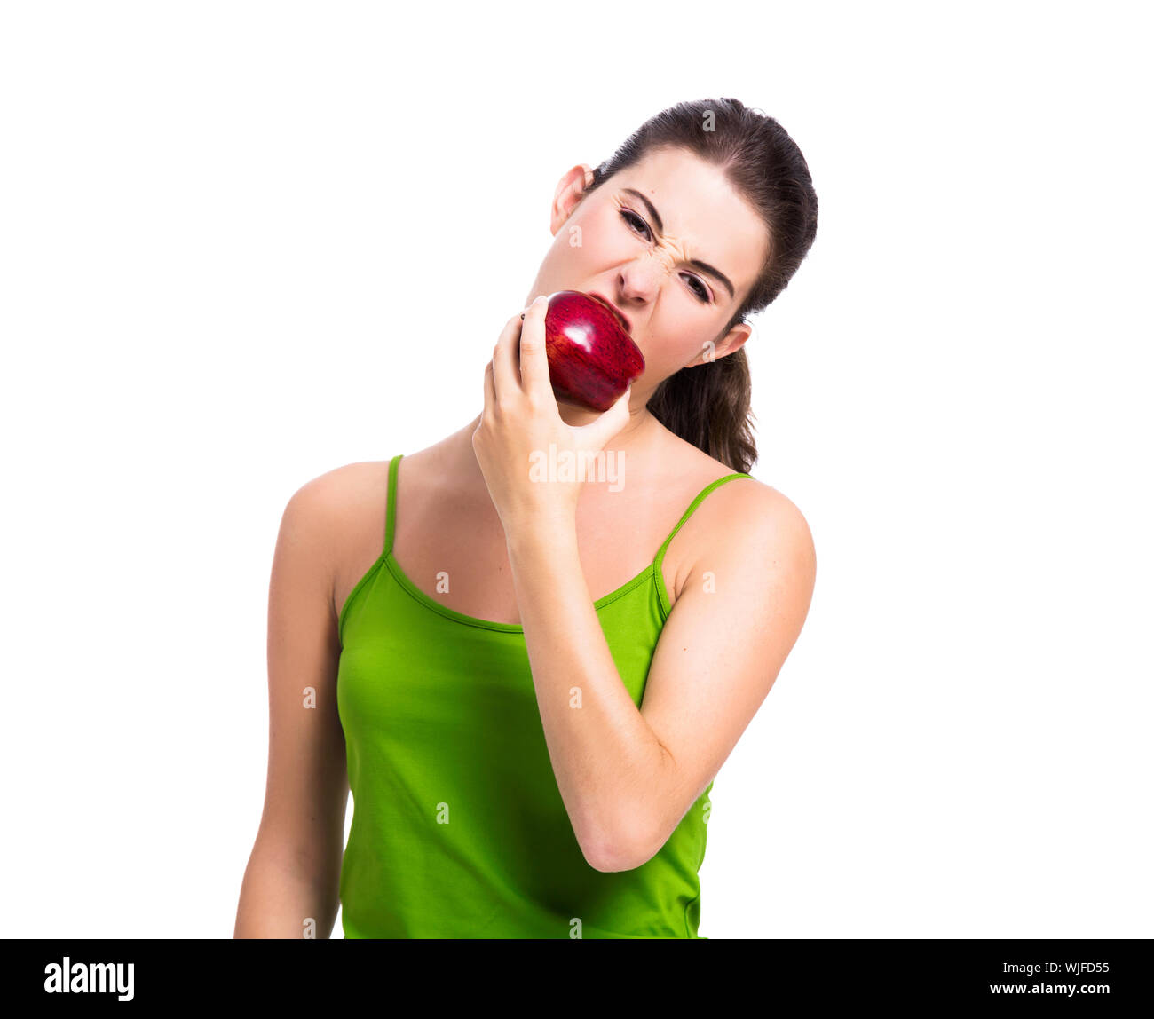 Healthy woman biting a fresh apple, isolated over a white background ...