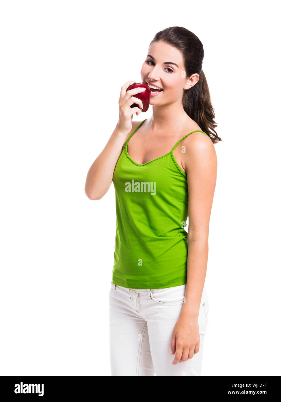 Healthy woman eating a fresh apple, isolated over a white background ...