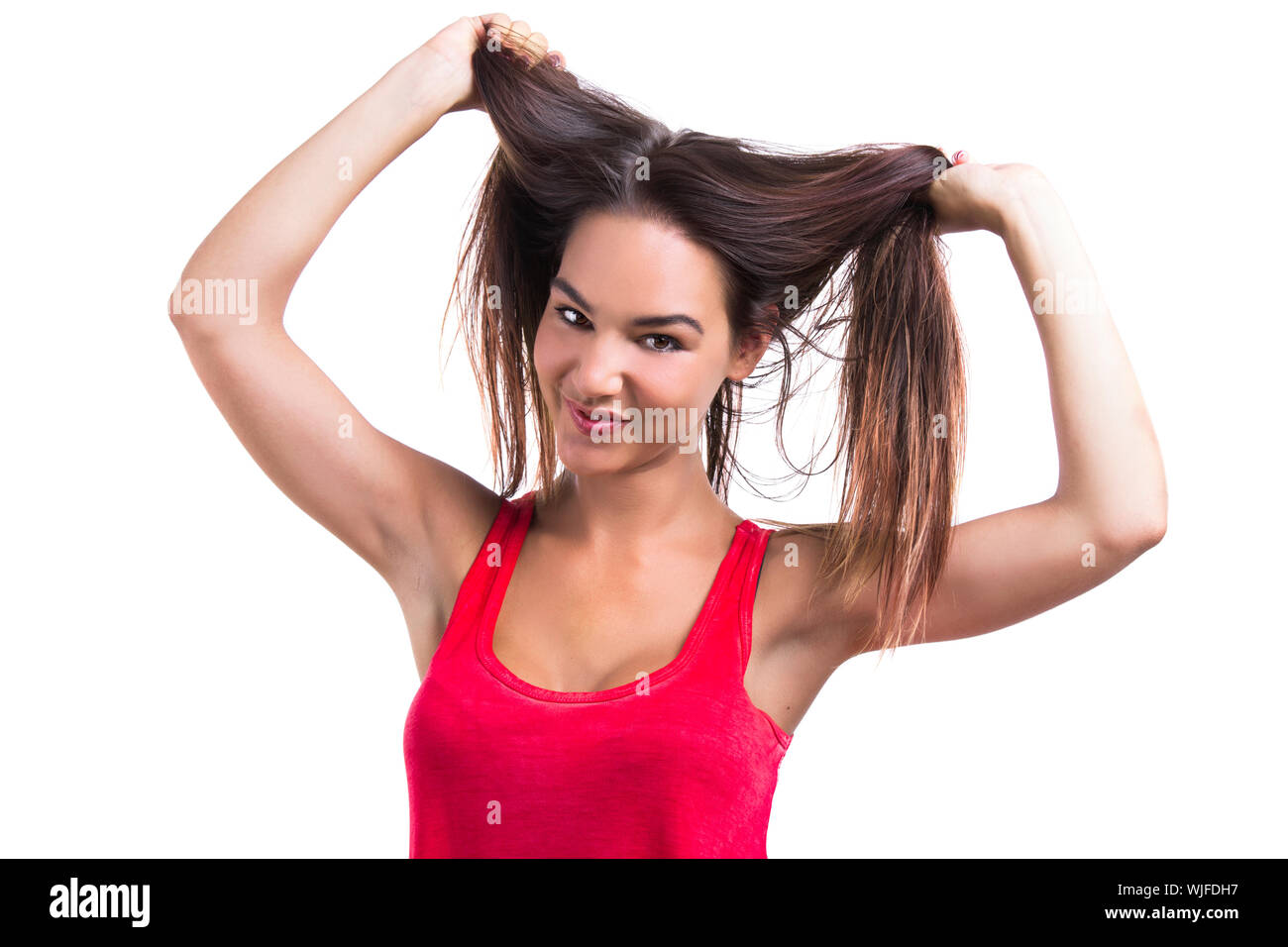 Beautiful young woman grabbing her own hair, isolated over white ...