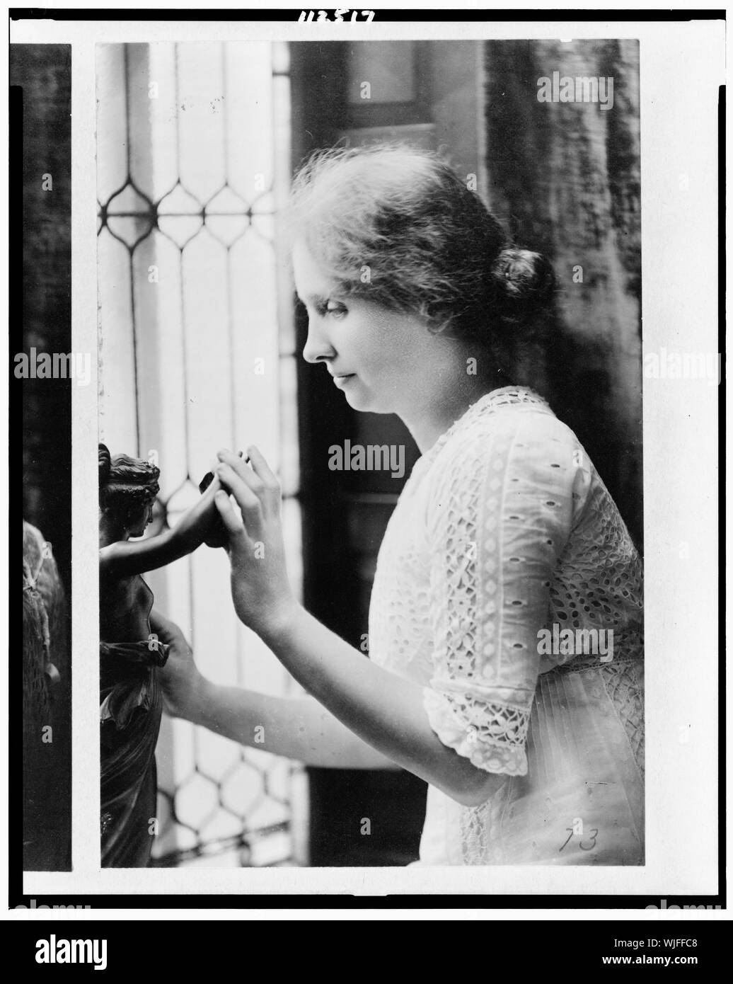 Helen Keller, half-length portrait, facing left, touching statue Stock ...