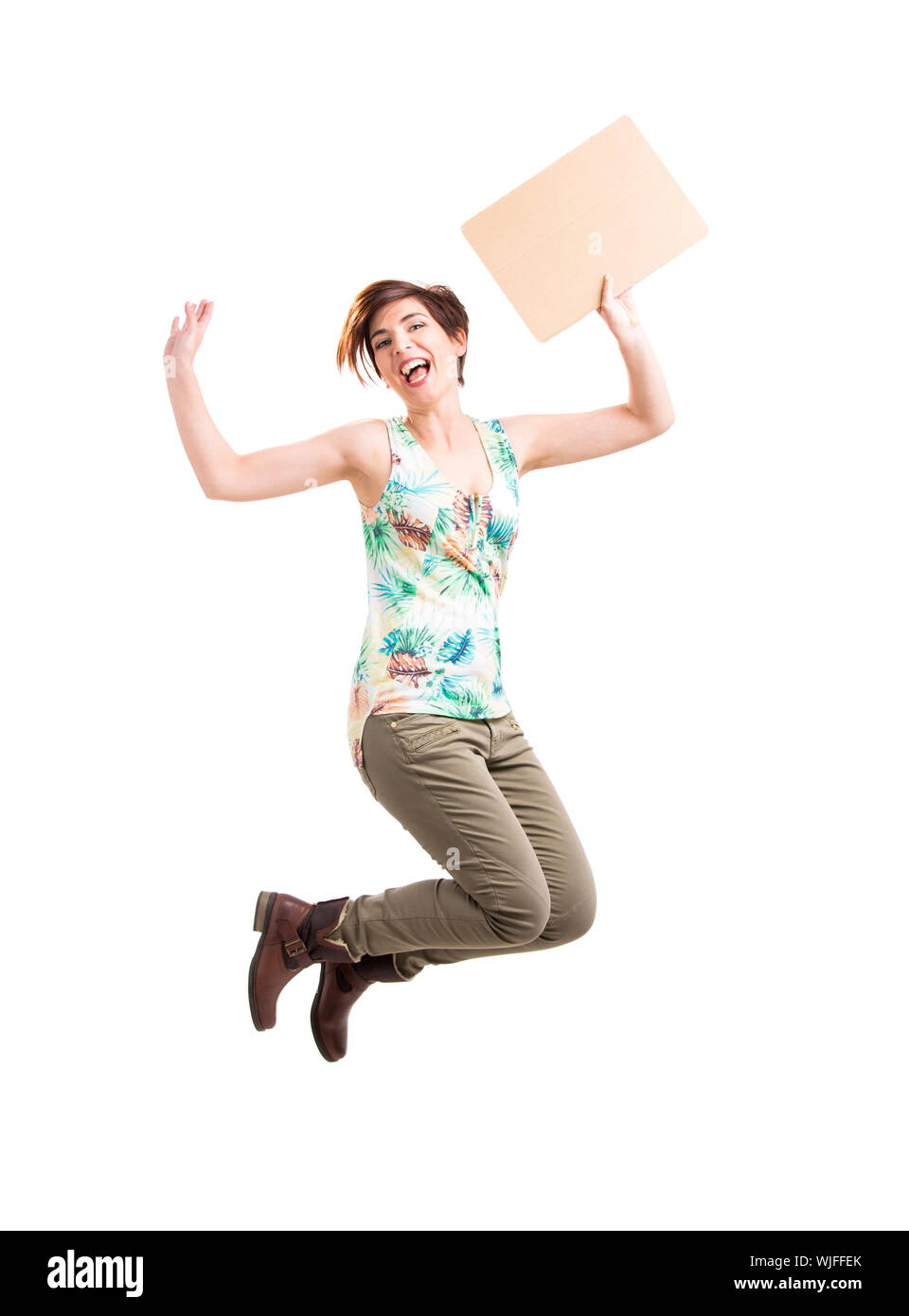 Beautiful and happy woman jumping and holding a cardboard, isolated ...
