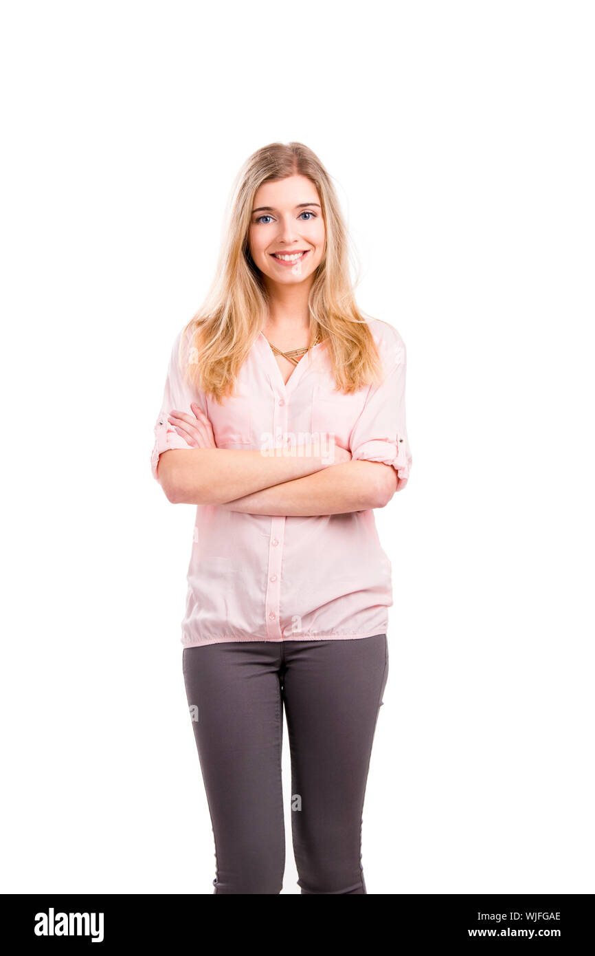 Beautiful young woman smiling and standing, isolated over a white ...