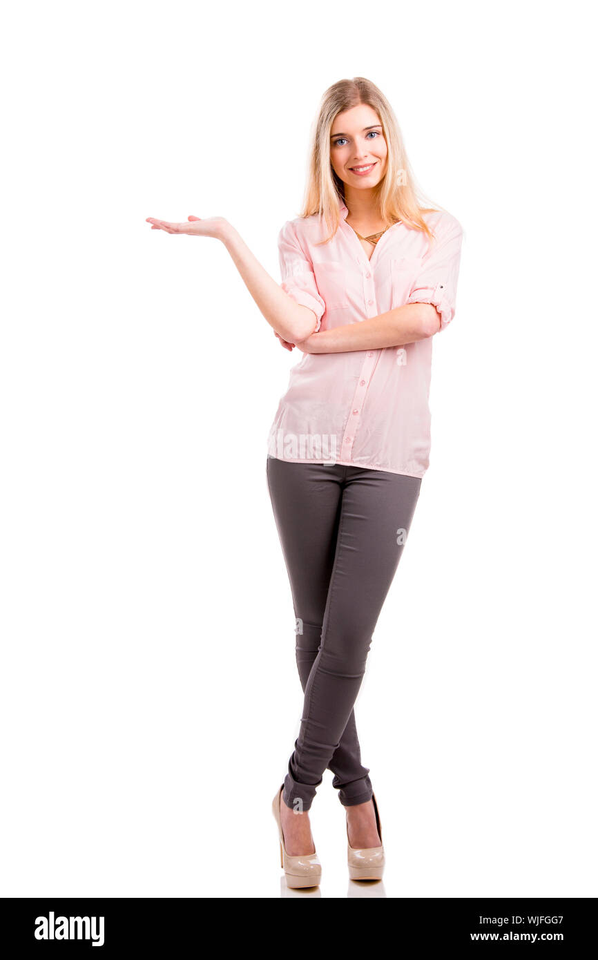 Beautiful young woman smiling and showing the palm of her right hand ...