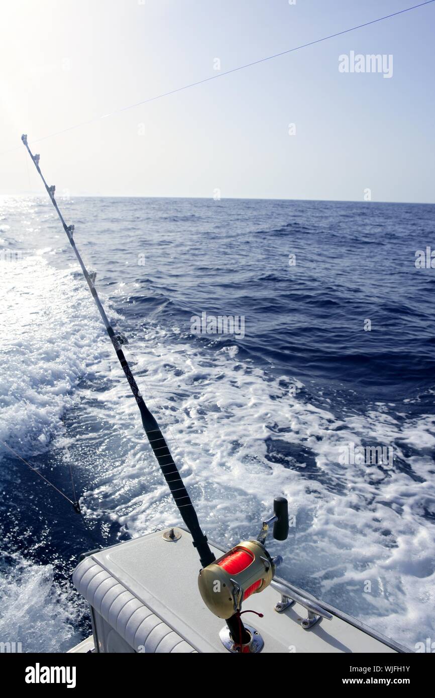 Fishing on boat with rod and reel Stock Photo - Alamy