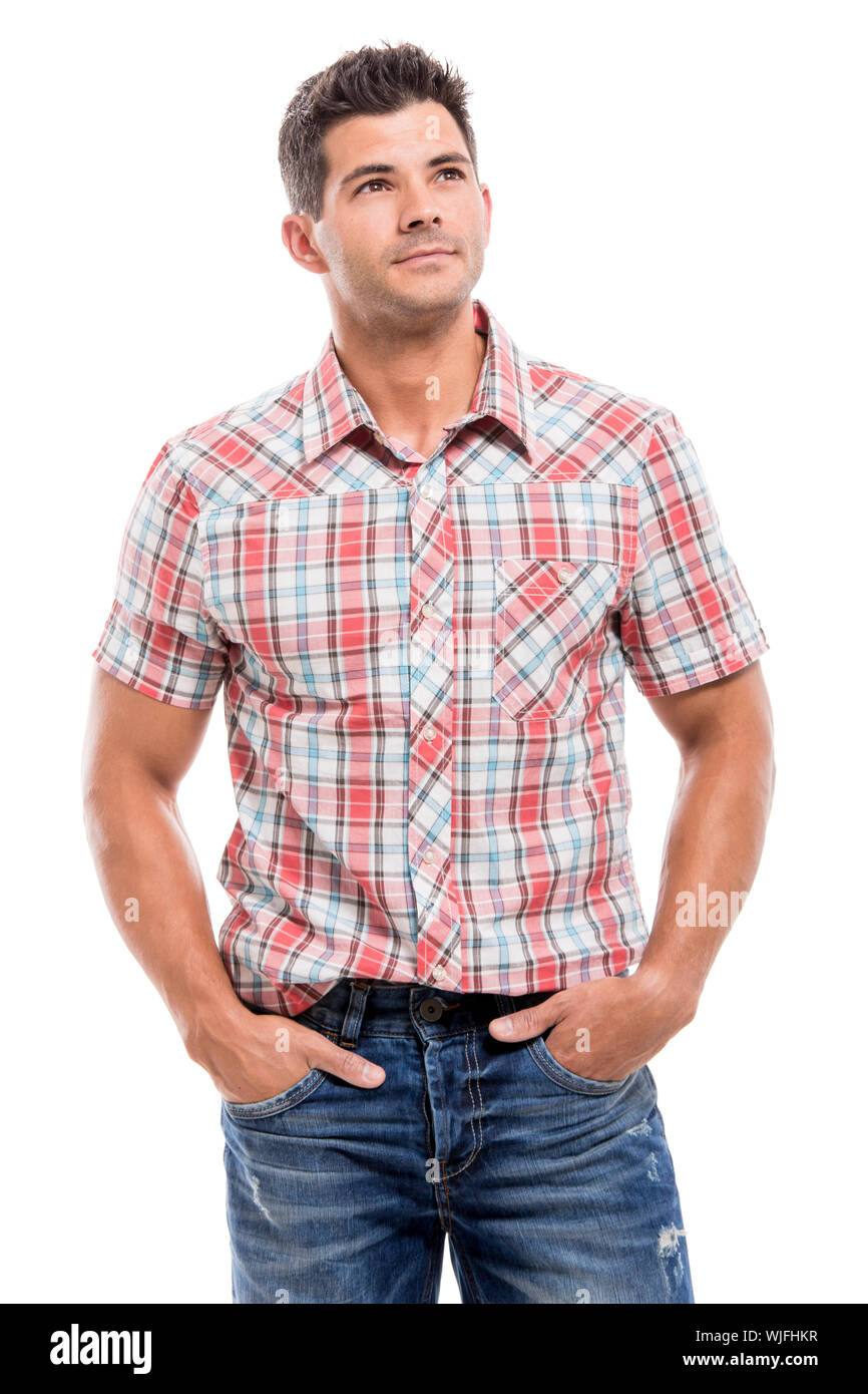 Handsome latin man standing over a white background and looking up ...