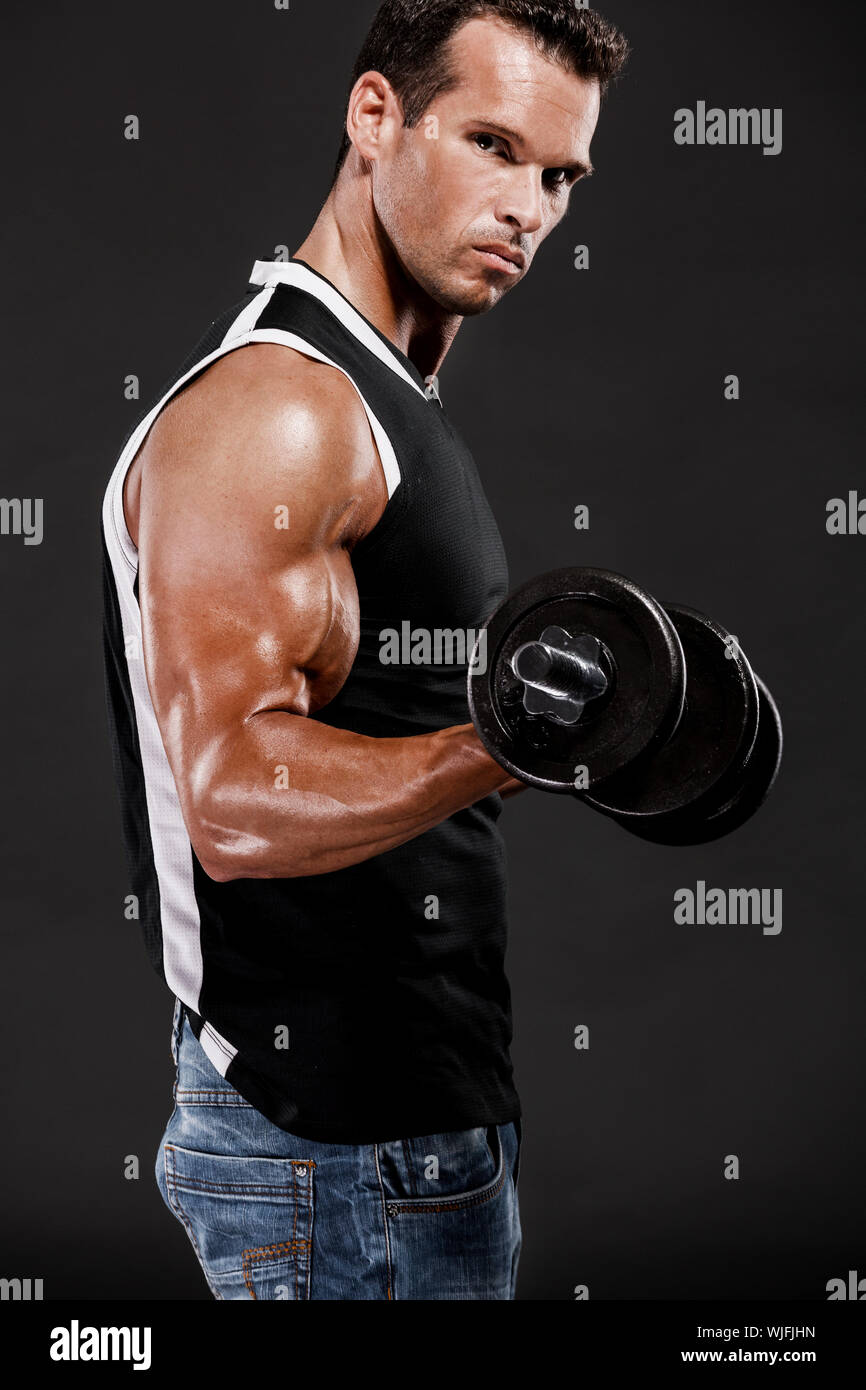 Muscle man in studio lifting weights, isolated over a white background ...