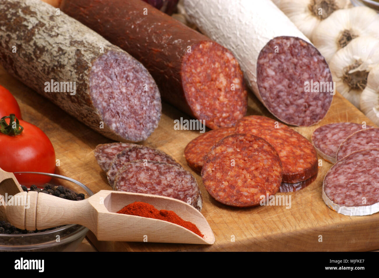 salami and some slices salami on a timber board Stock Photo - Alamy