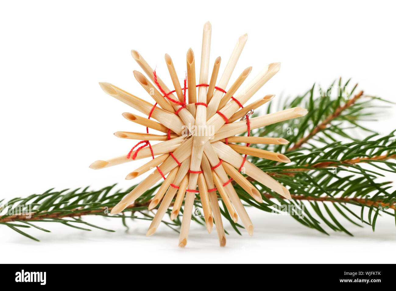 straw star in front of a branch on white background Stock Photo - Alamy