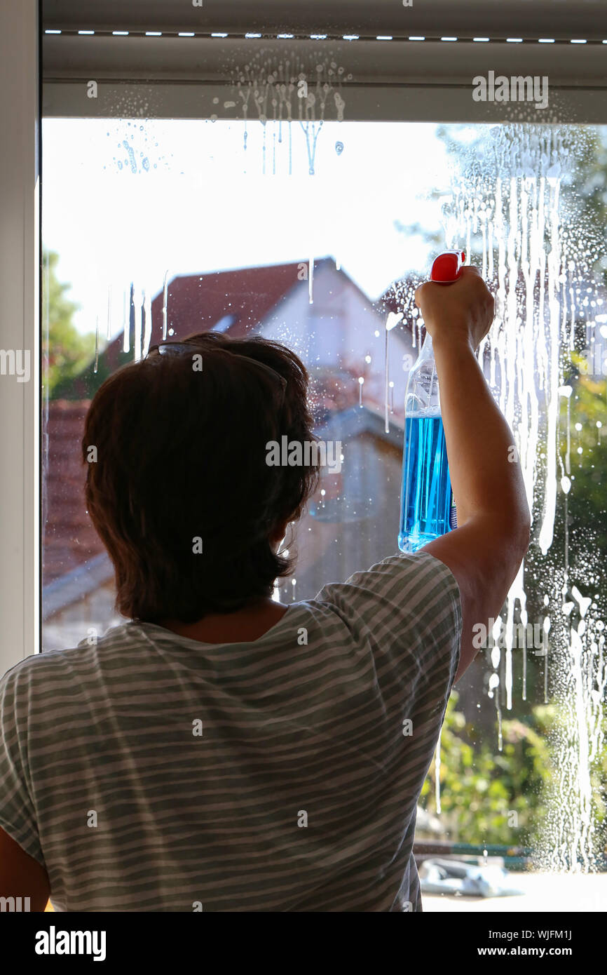 Cleaning concept. Woman washing window, close up Stock Photo - Alamy
