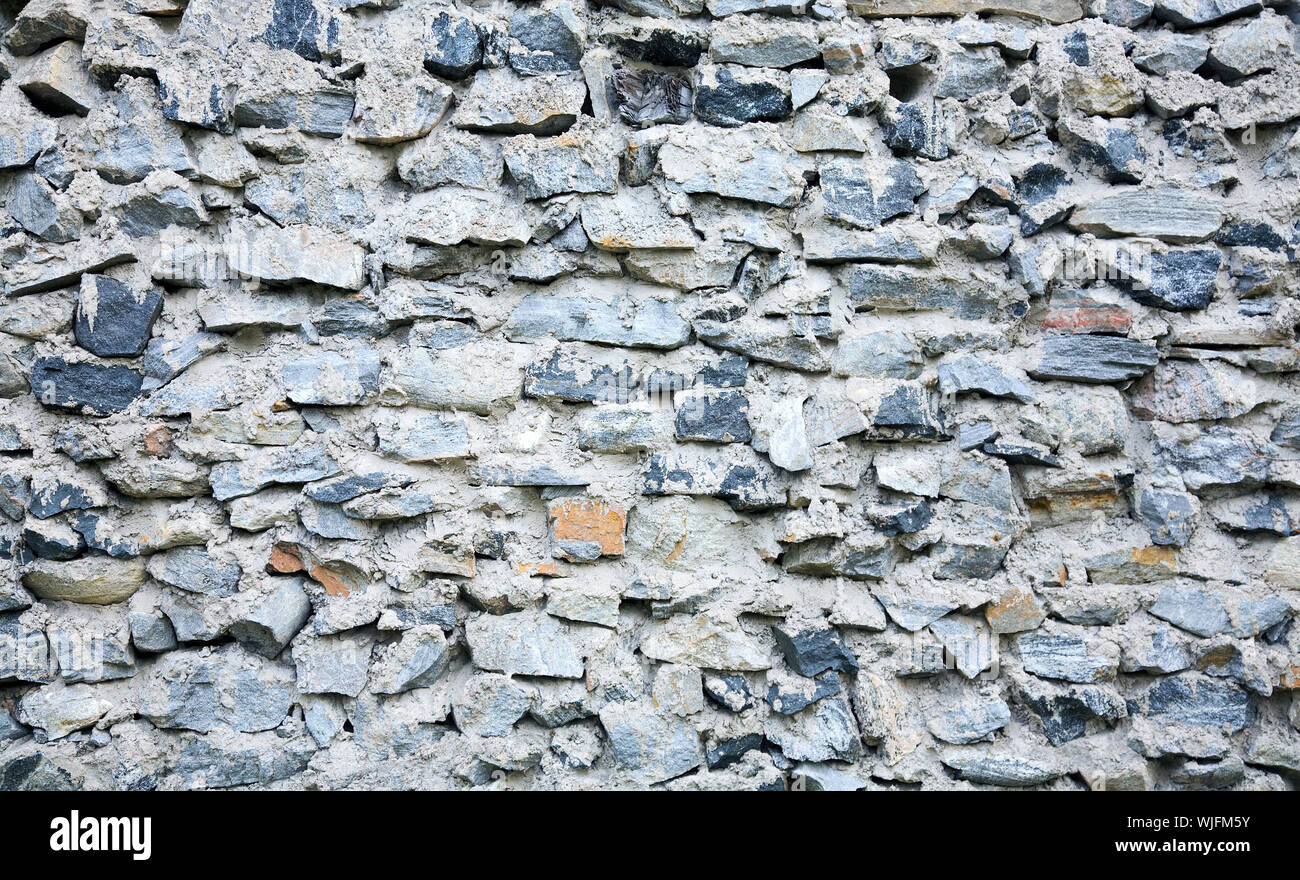 Ancient grunge rough stone wall of a building Stock Photo - Alamy