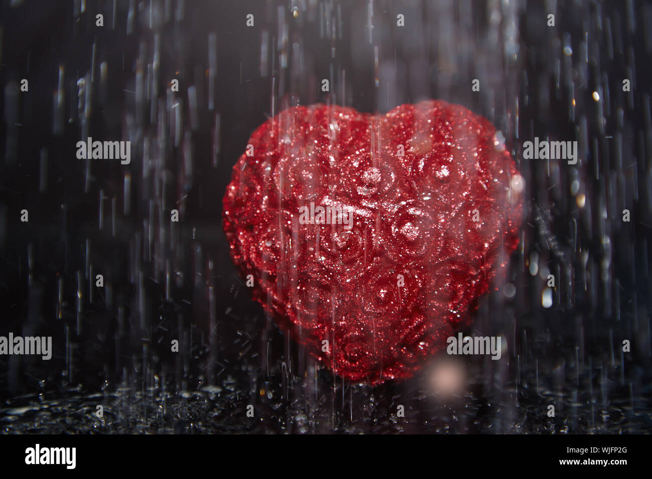 Heart shape in heavy rain. Close-up view Stock Photo - Alamy