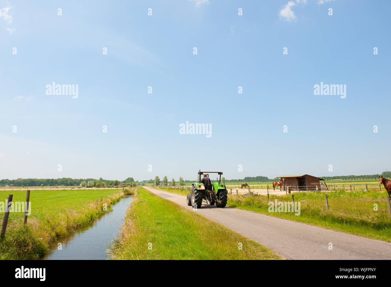 Typical Dutch landscape with tractor and farmland Stock Photo - Alamy