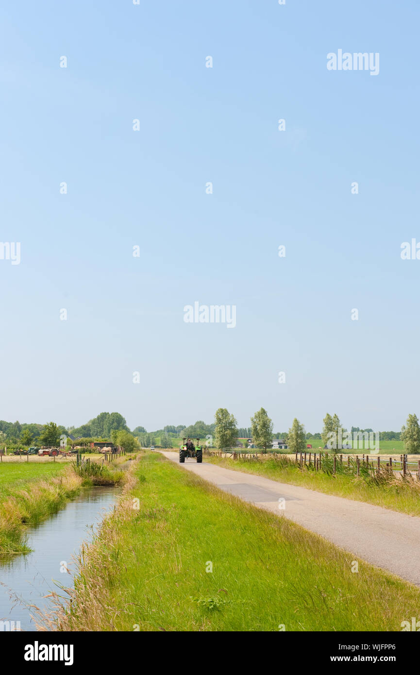 Typical Dutch landscape with tractor and farmland Stock Photo - Alamy