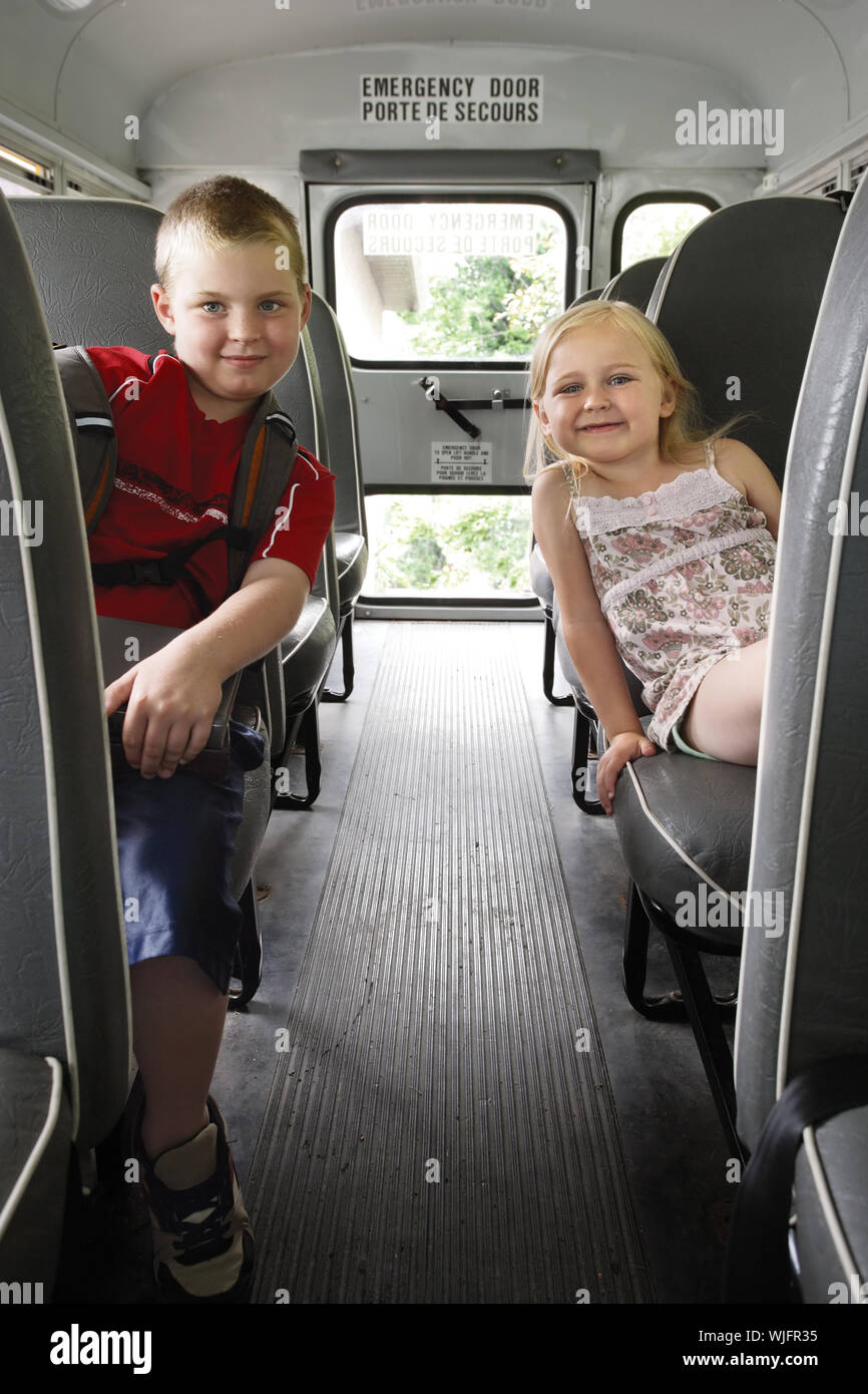 Photo of two happy children sitting in a school bus Stock Photo - Alamy