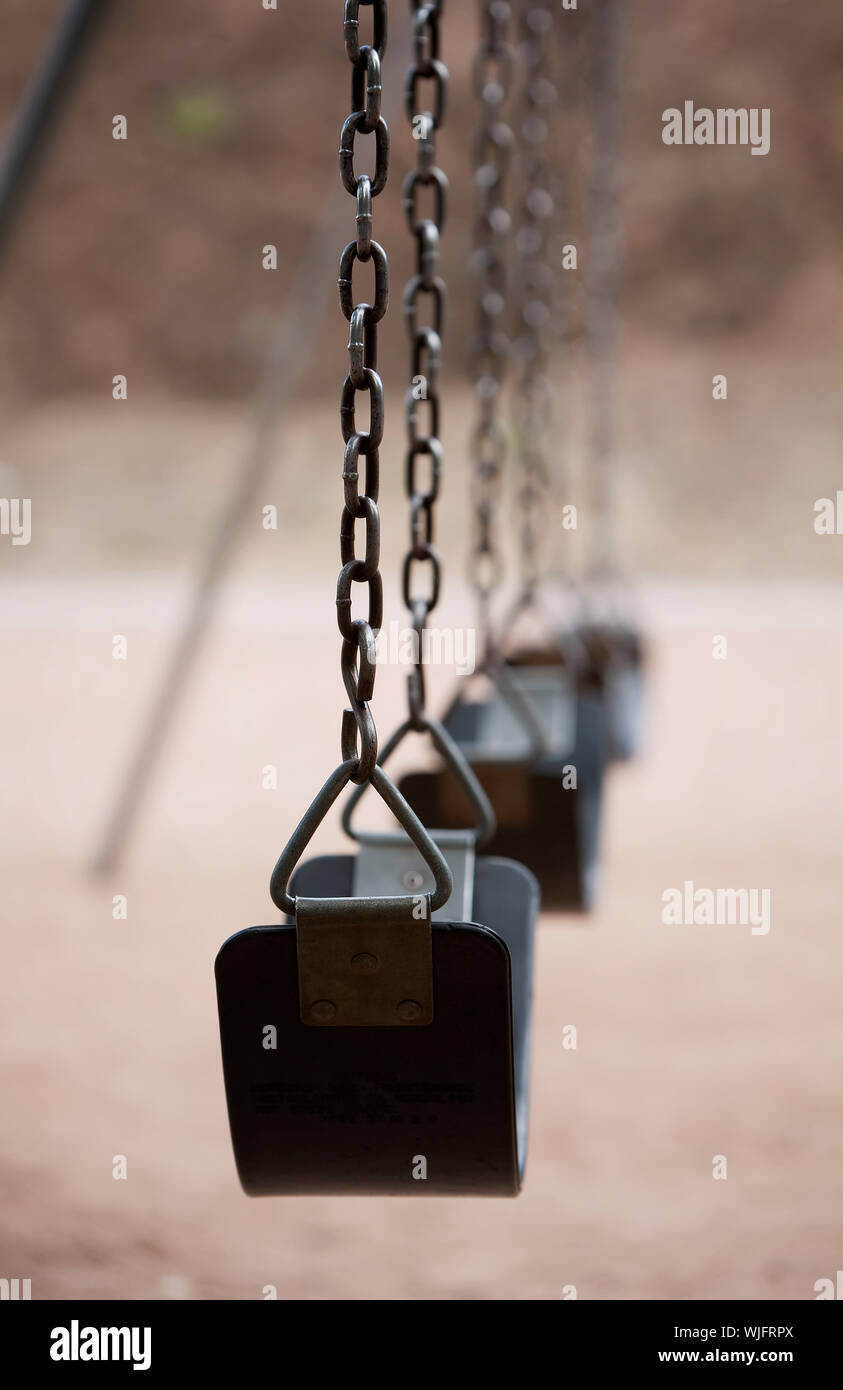 Old style playground swing with chains and rubber seat Stock Photo - Alamy