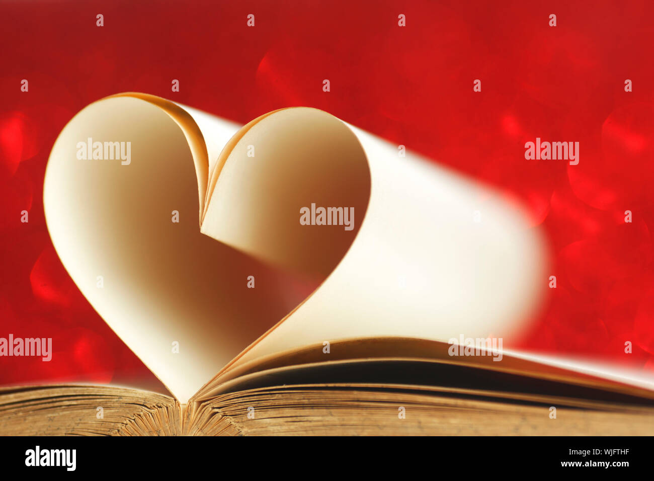 Heart made of blank pages inside a book on glitter background Stock ...