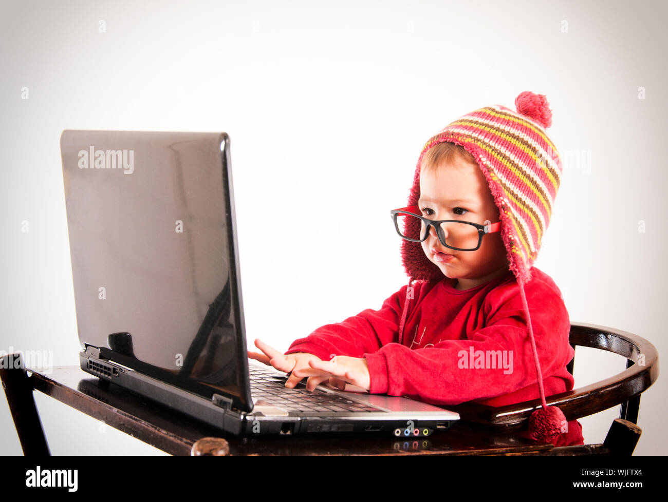 Little baby hacker typing on the laptop computer,isolated on white ...