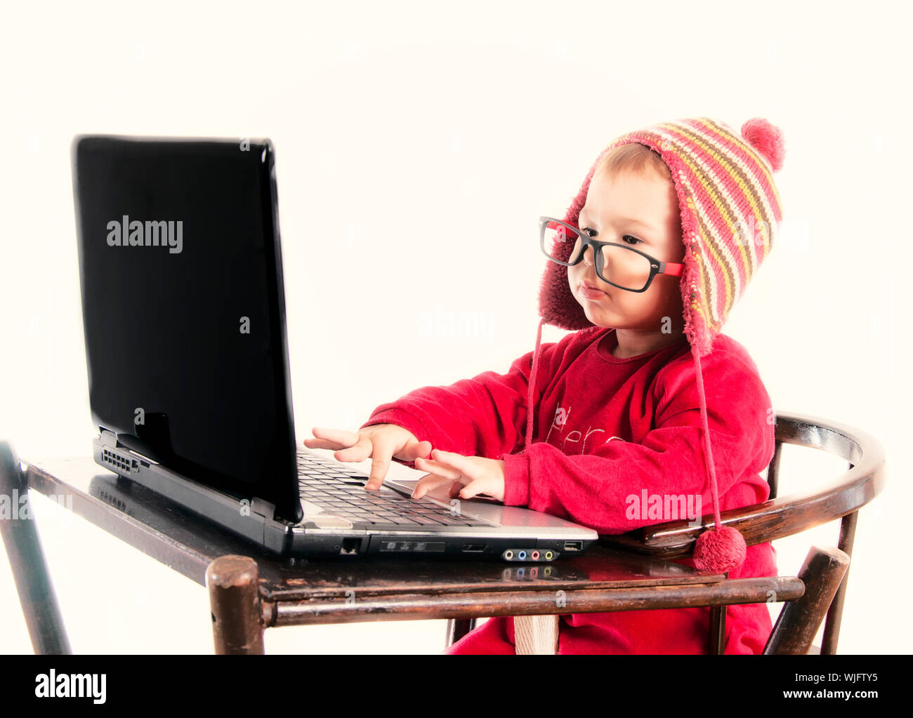 Little baby hacker typing on the laptop computer,isolated on white ...