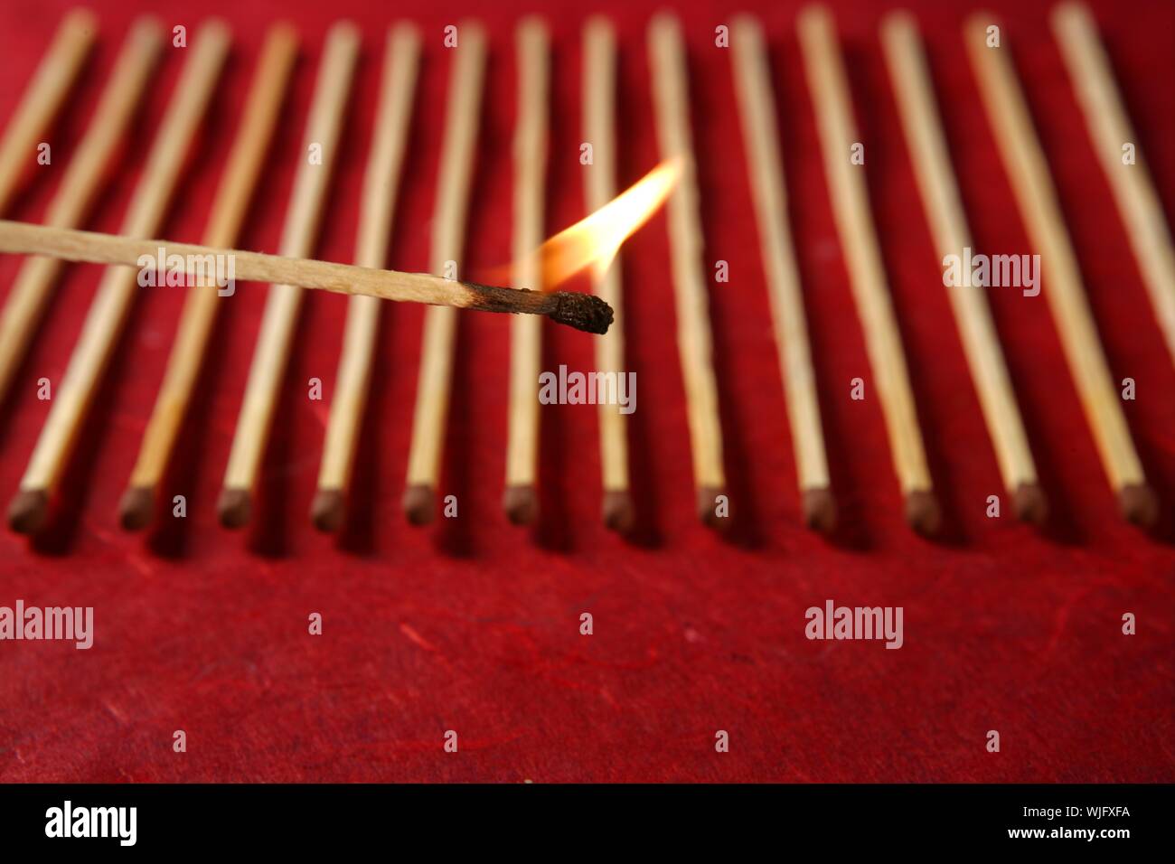 Light wooden matches arrangement in a row over red background Stock ...