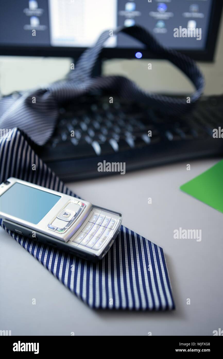 Businessman break, left his tie and phone over computer keyboard Stock ...