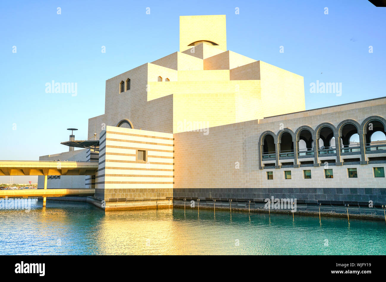 Museum of Islamic Arts building and approach in sunrise glow in Doha ...