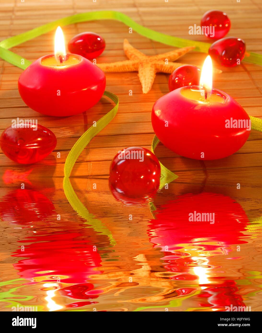 spa candle and water reflection showing zen concept Stock Photo - Alamy