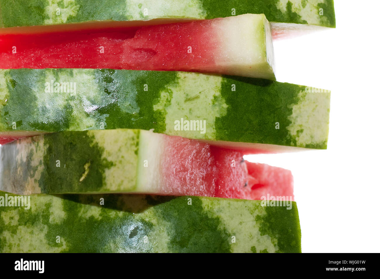 Stack of fresh pieces of watermelon isolated over white Stock Photo - Alamy