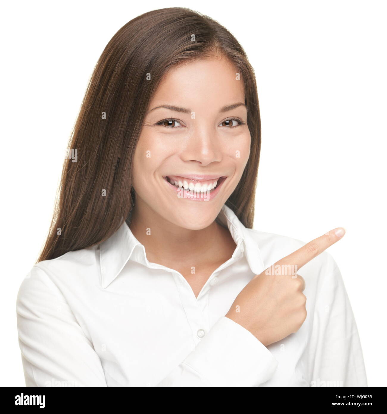 Woman pointing. Closeup portrait of young smiling woman pointing at ...