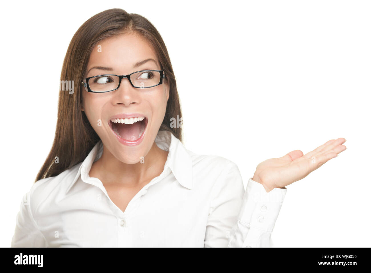Young woman showing product with open hand palm - excited expression on ...