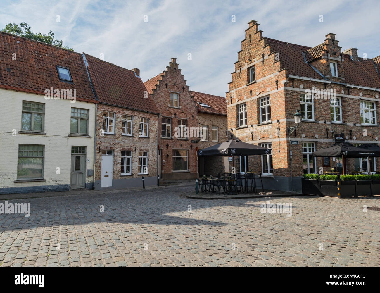 Beautiful historical stone houses, on a cobblestone street in Bruges ...
