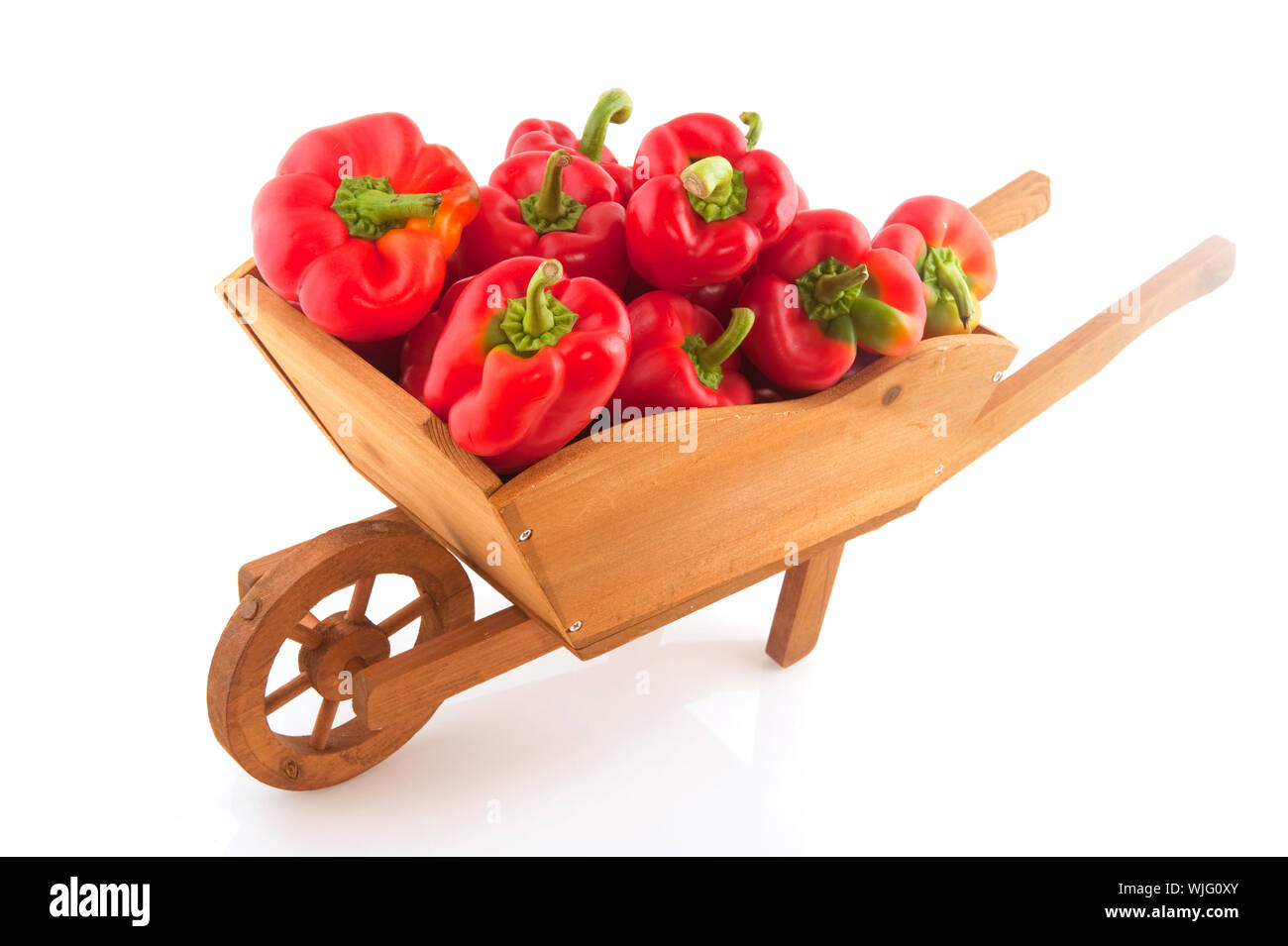 Wooden wheelbarrow full with fresh red paprika Stock Photo - Alamy