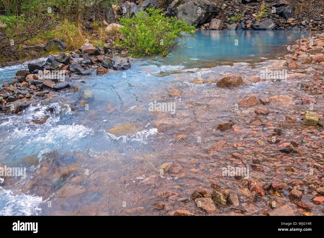 Blue spring in the mountains, source of crystal pure natural water ...