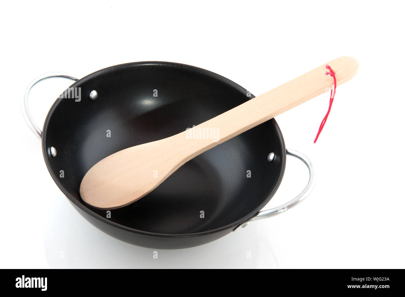 Black wok with wooden spoon Stock Photo - Alamy