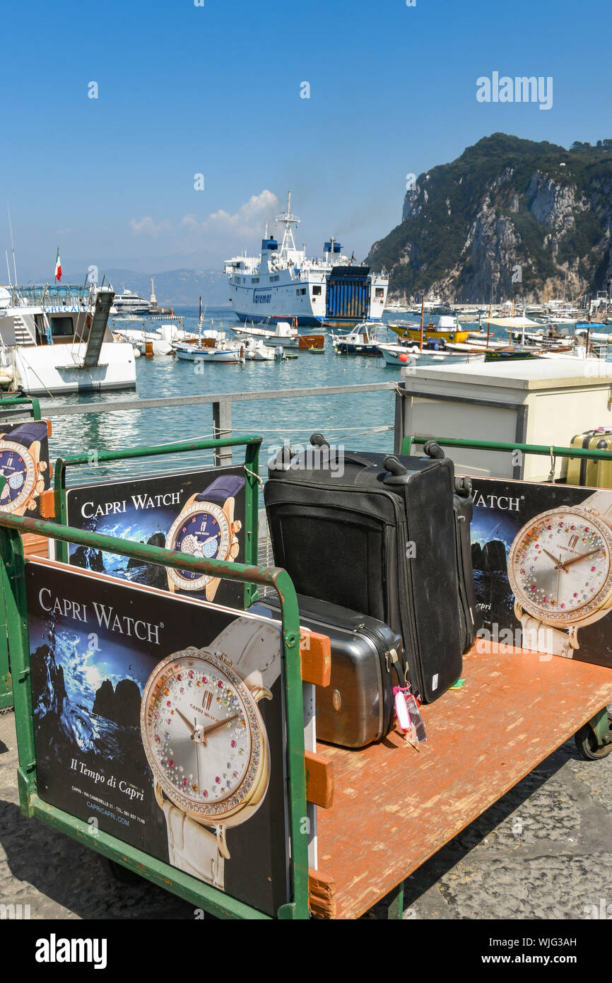 ISLE OF CAPRI, ITALY - AUGUST 2019: Luggage on a trolley in the port on ...
