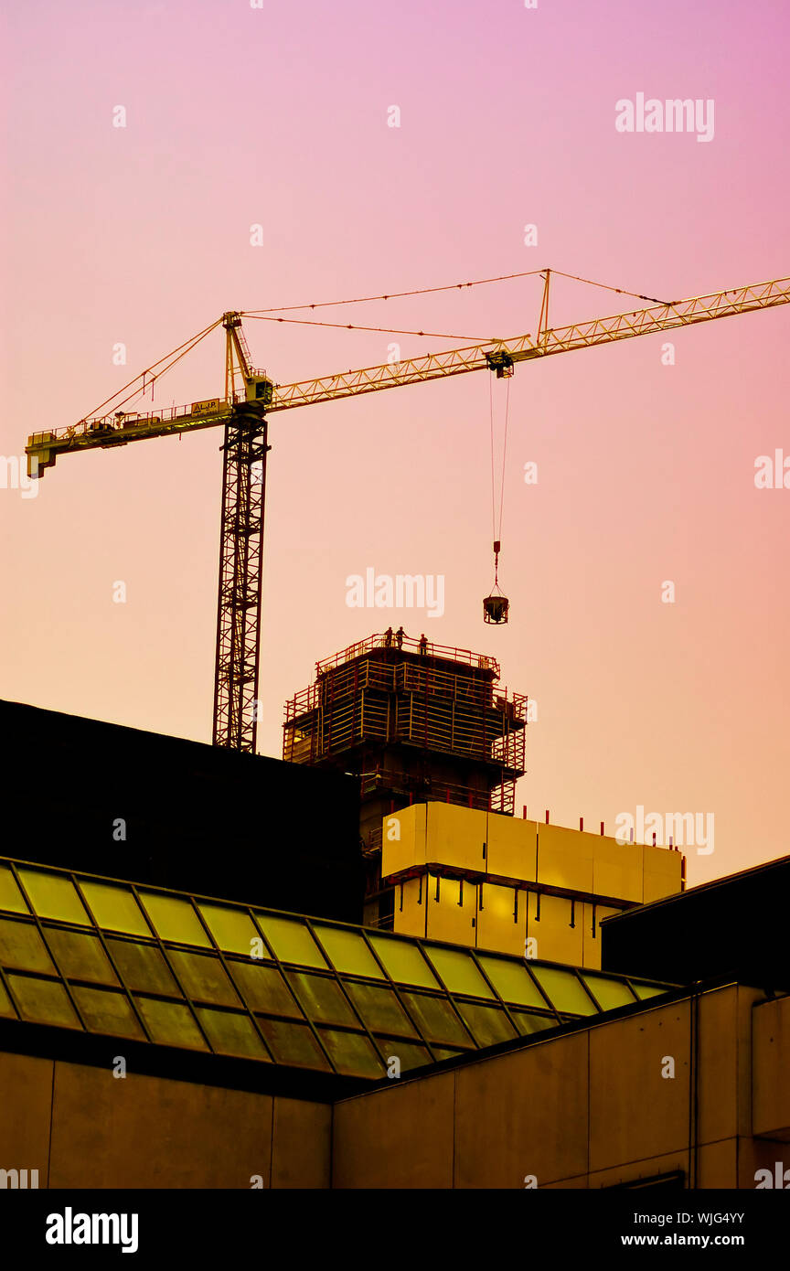 Sunset on a construction site, people working Stock Photo - Alamy
