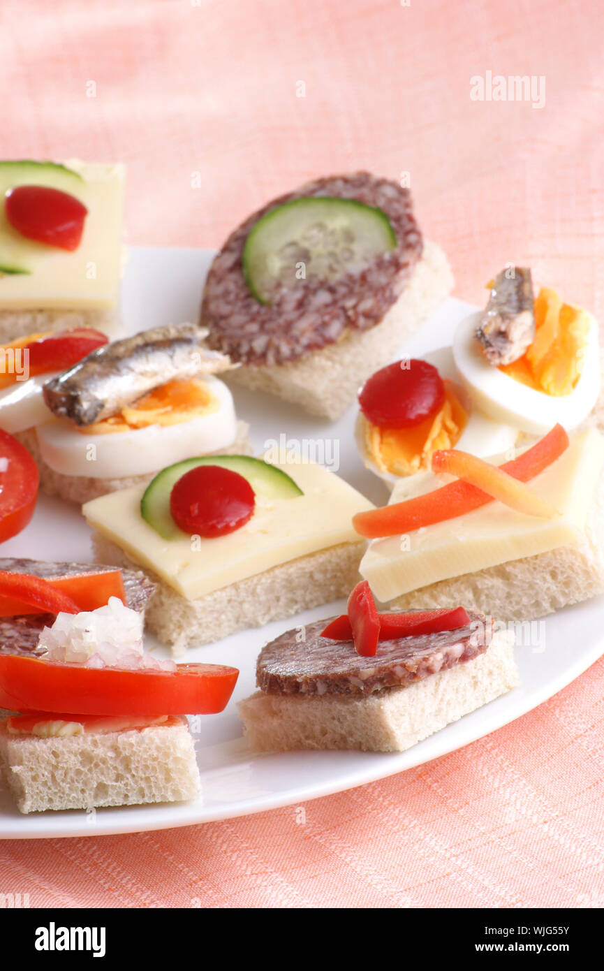 some party nibbles on a white plate Stock Photo - Alamy