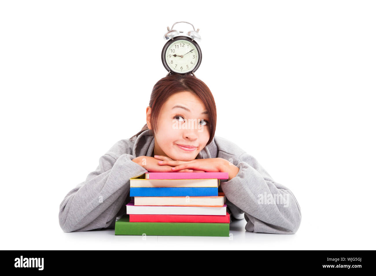 happy young student thinking clock with books Stock Photo - Alamy