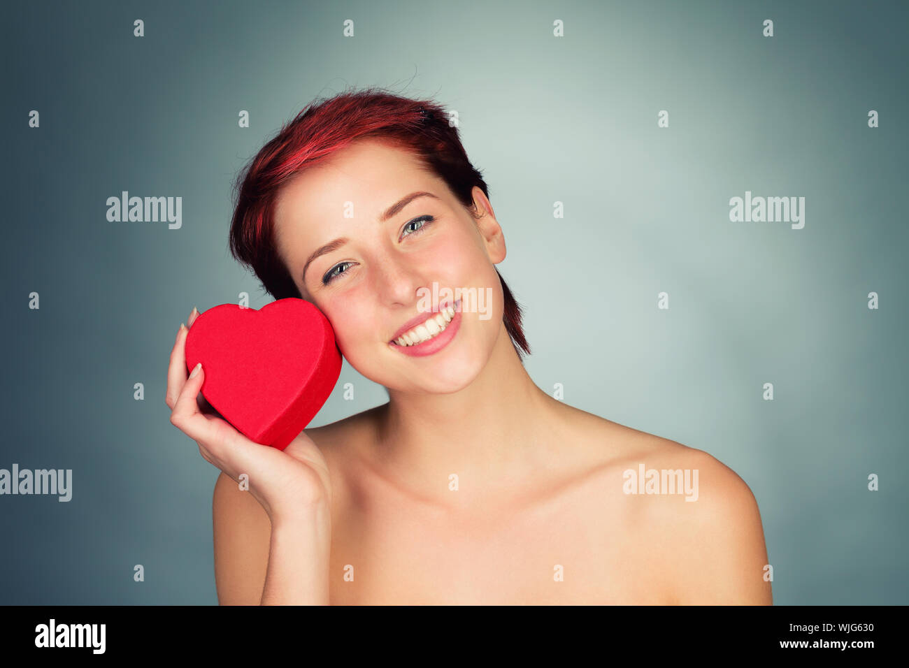 young happy woman cuddling with a red heart Stock Photo - Alamy