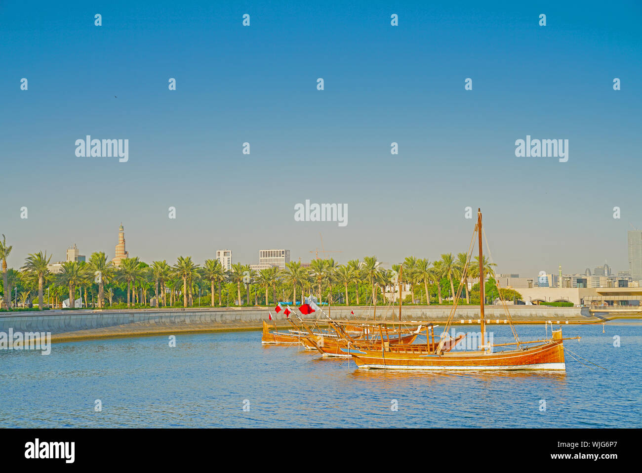 Dhow moored in bay with old town part of Doha city in background with ...