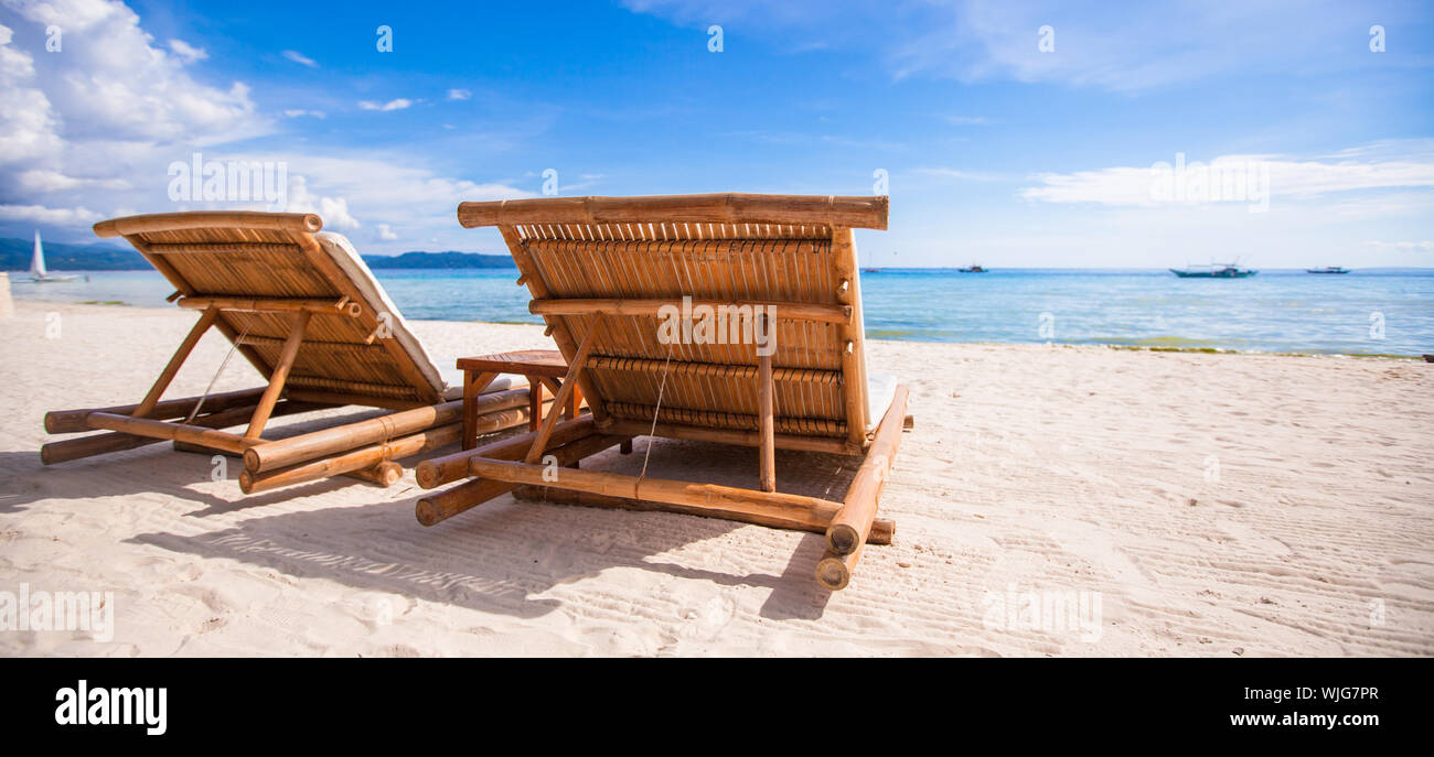 Beach wooden chairs for vacations on tropical beach Stock Photo - Alamy