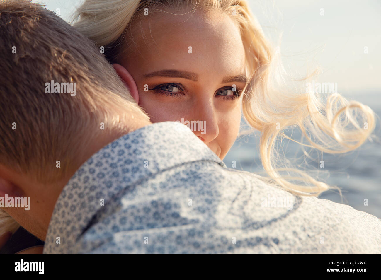 Young Woman Looking Over Boyfriends Shoulder Stock Photo - Alamy