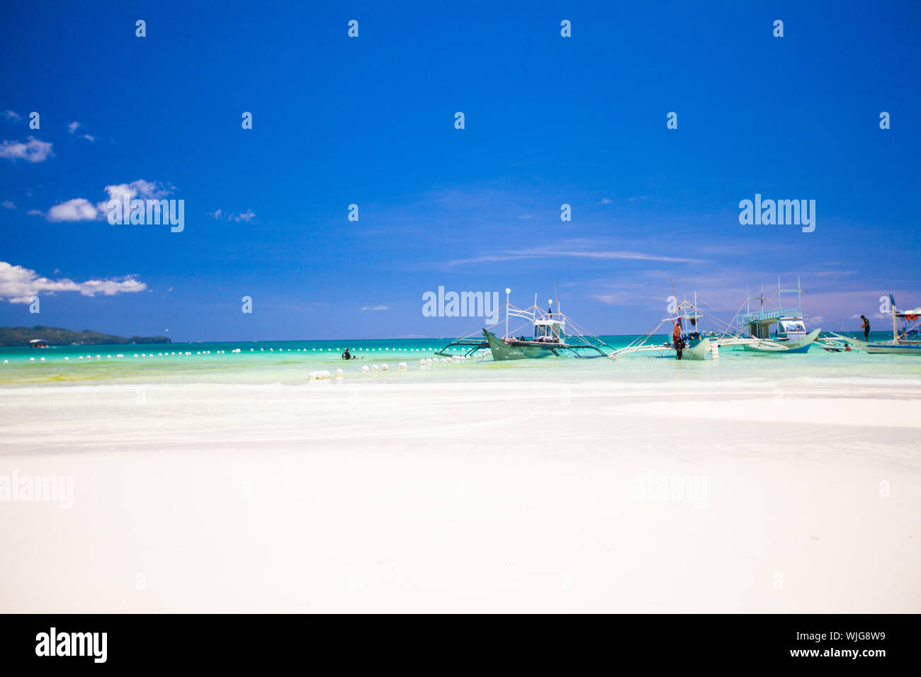 Perfect tropical beach with turquoise water and sailboats Stock Photo ...
