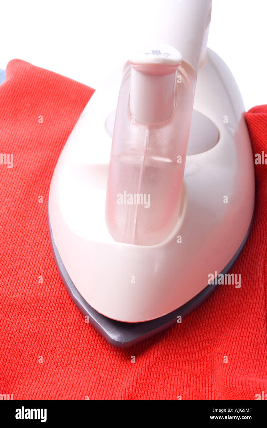 electric iron on red shirt Stock Photo - Alamy