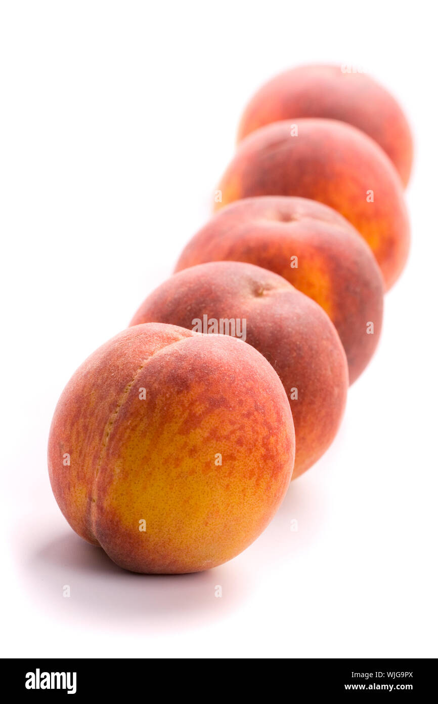 five peaches on white background Stock Photo - Alamy
