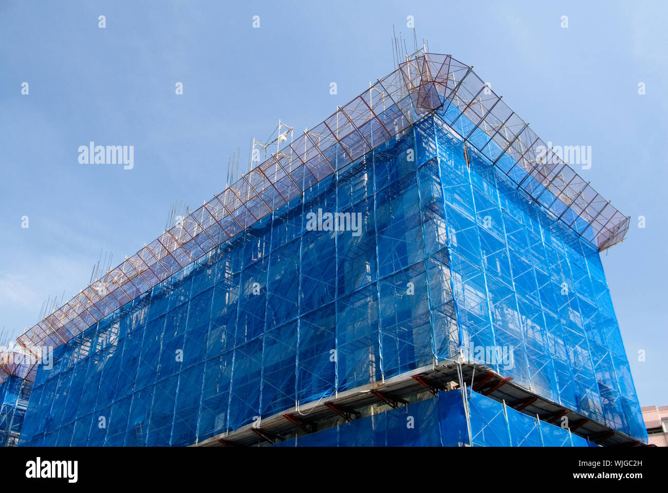 It is a blue building that under construction Stock Photo - Alamy