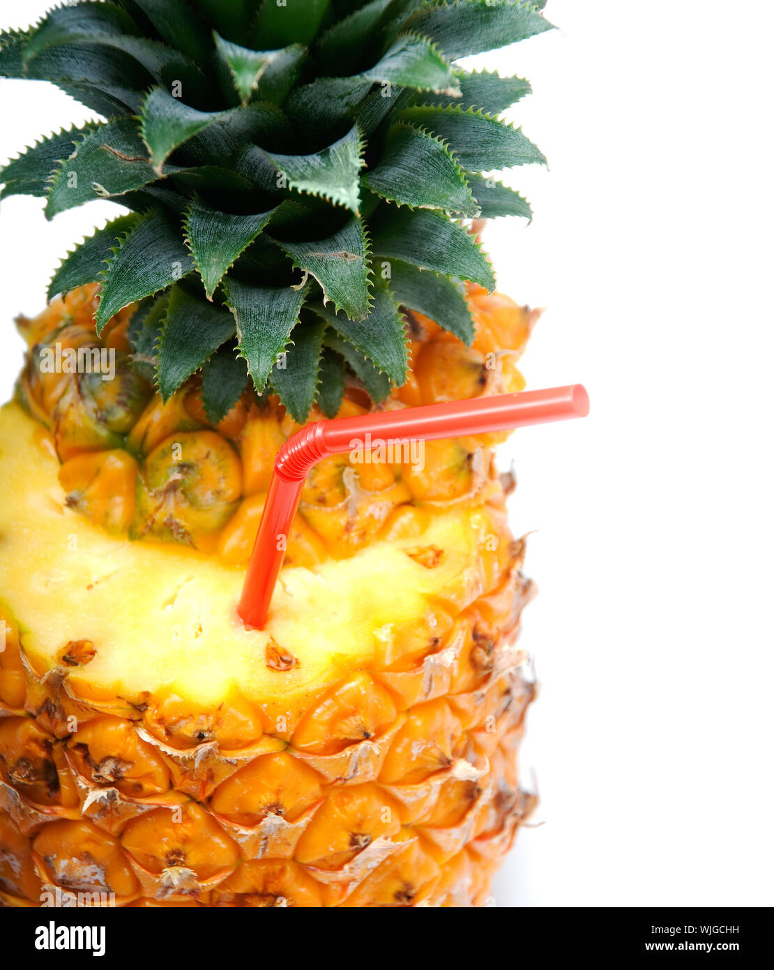 ripe pineapple cutted on top with red and blue straws isolated on white ...