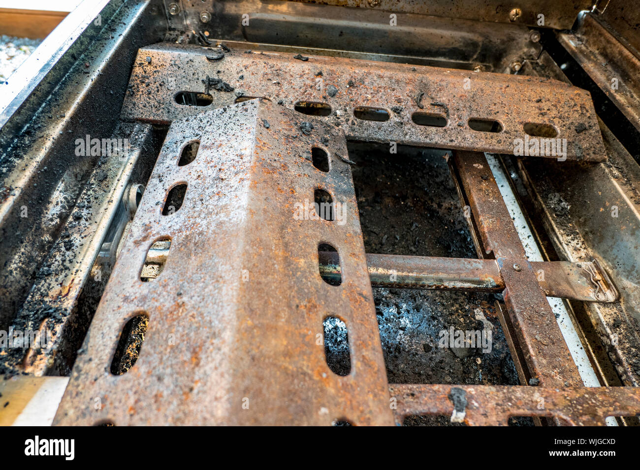 Fuel elements of a gas barbecue rusted and contaminated Stock Photo - Alamy