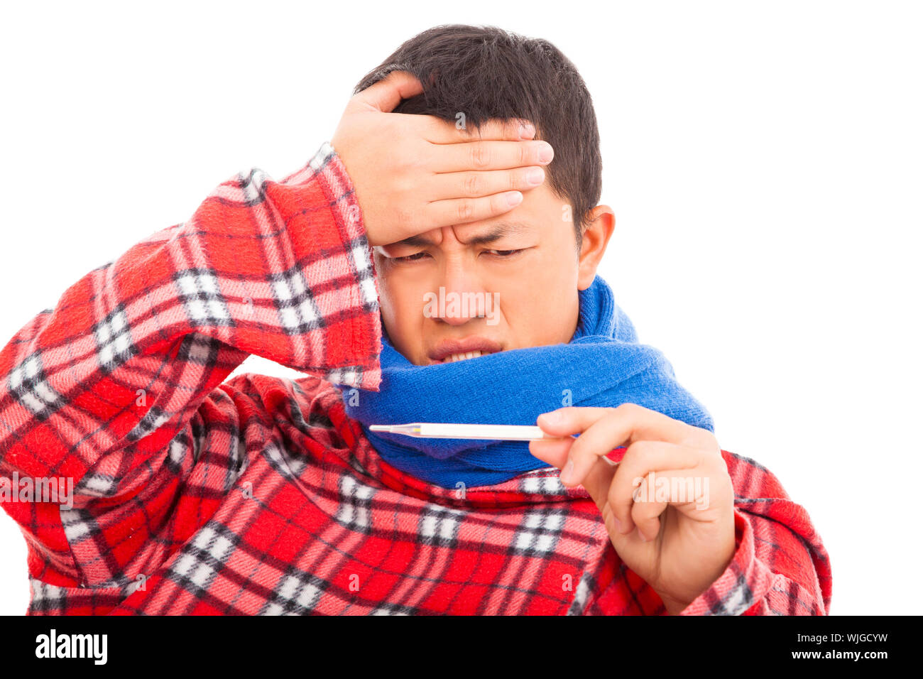 Sick young man measuring fever temperature with thermometer Stock Photo ...